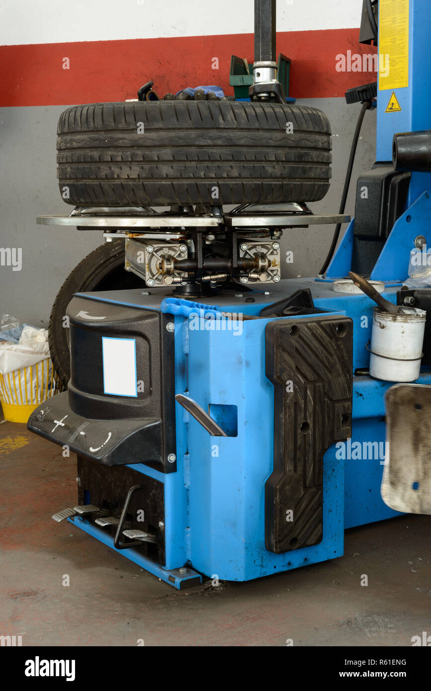 Tire on fixing tool machine Stock Photo - Alamy