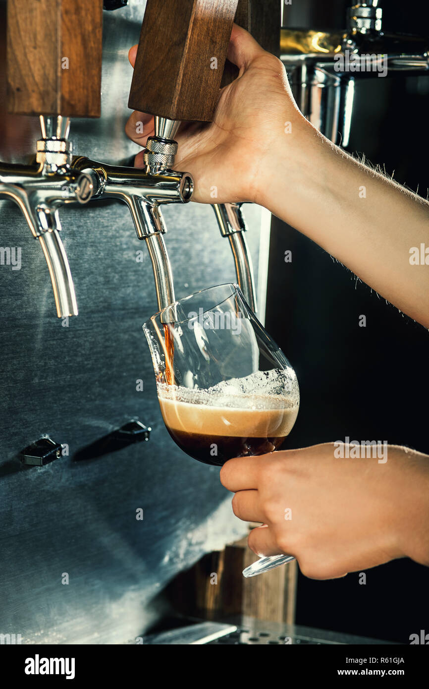 Hand of bartender pouring a large lager beer in tap Stock Photo - Alamy
