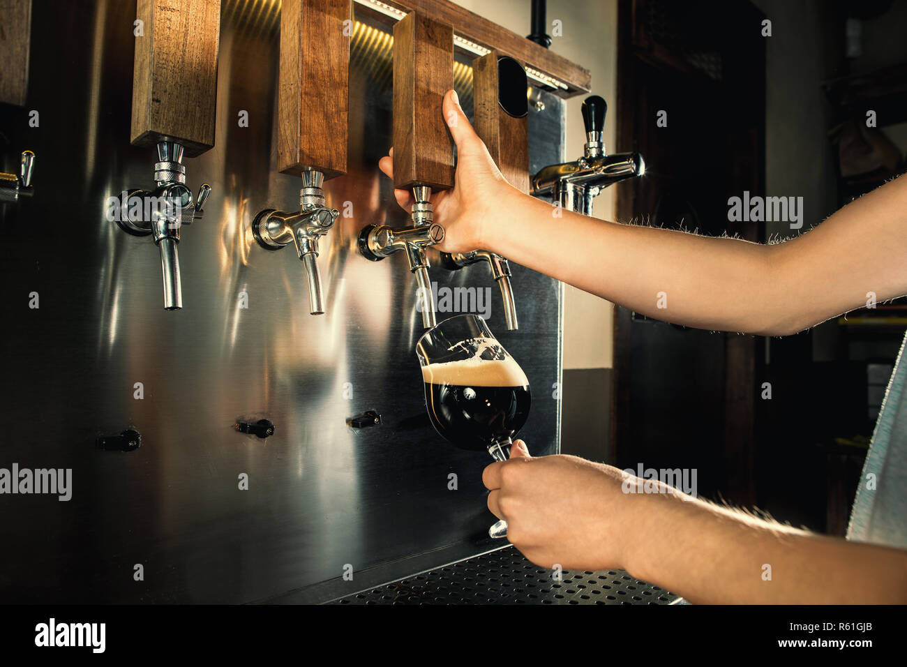 Hand of bartender pouring a large lager beer in tap Stock Photo - Alamy