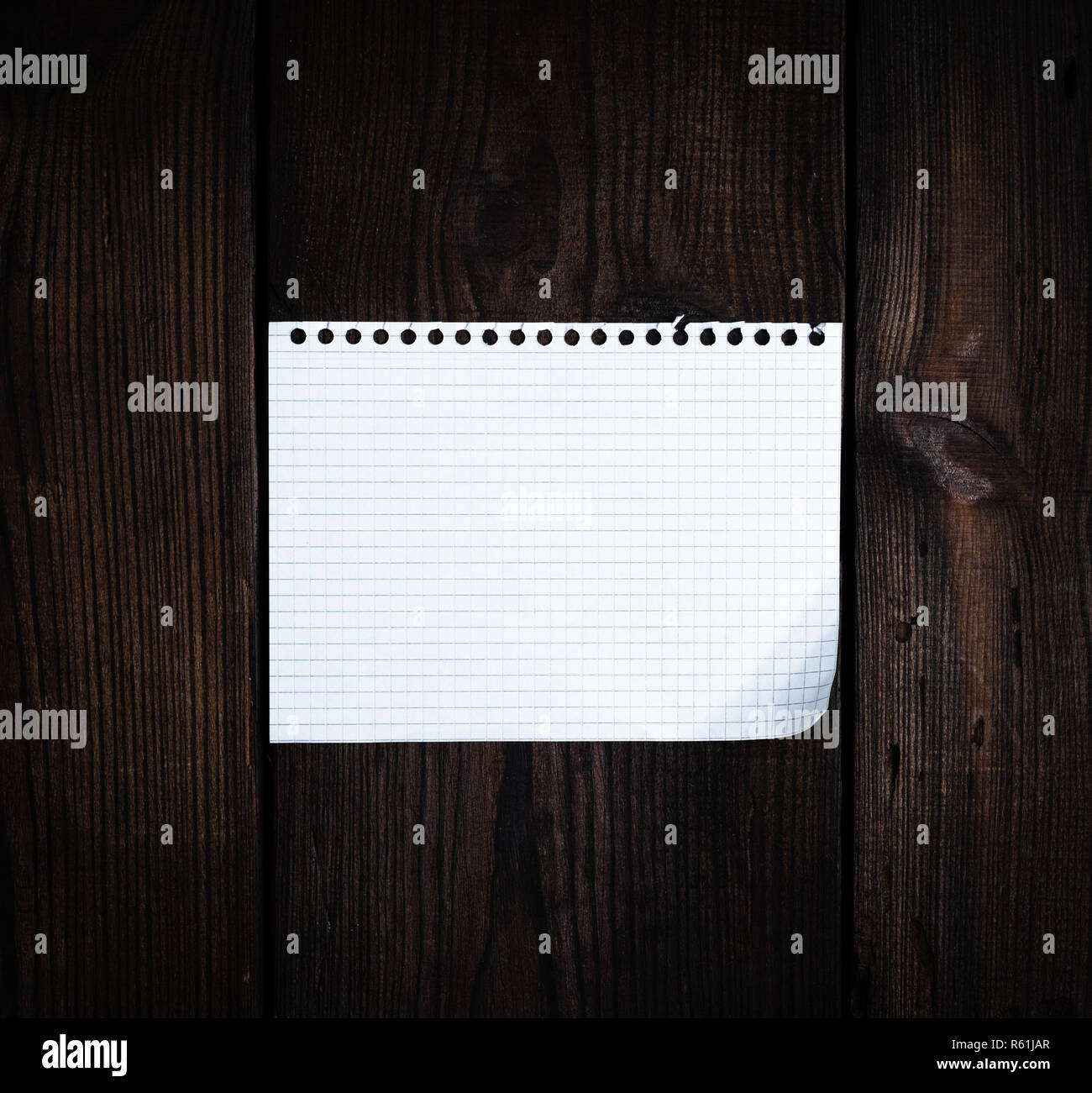 empty rectangular white sheet torn out of notepad on a brown wooden ...
