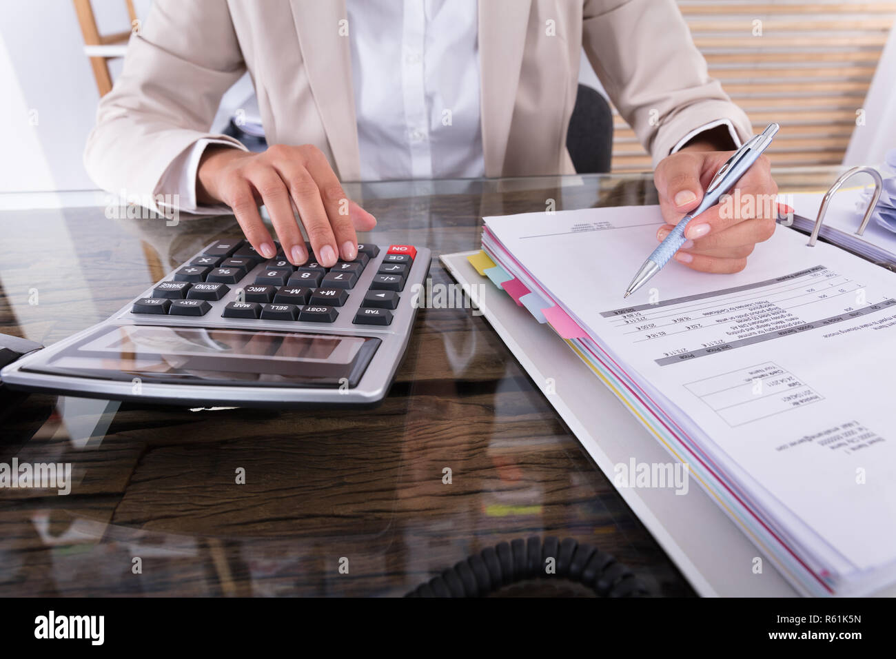 Businesswoman Hand Calculating Invoice Using Calculator Stock Photo - Alamy