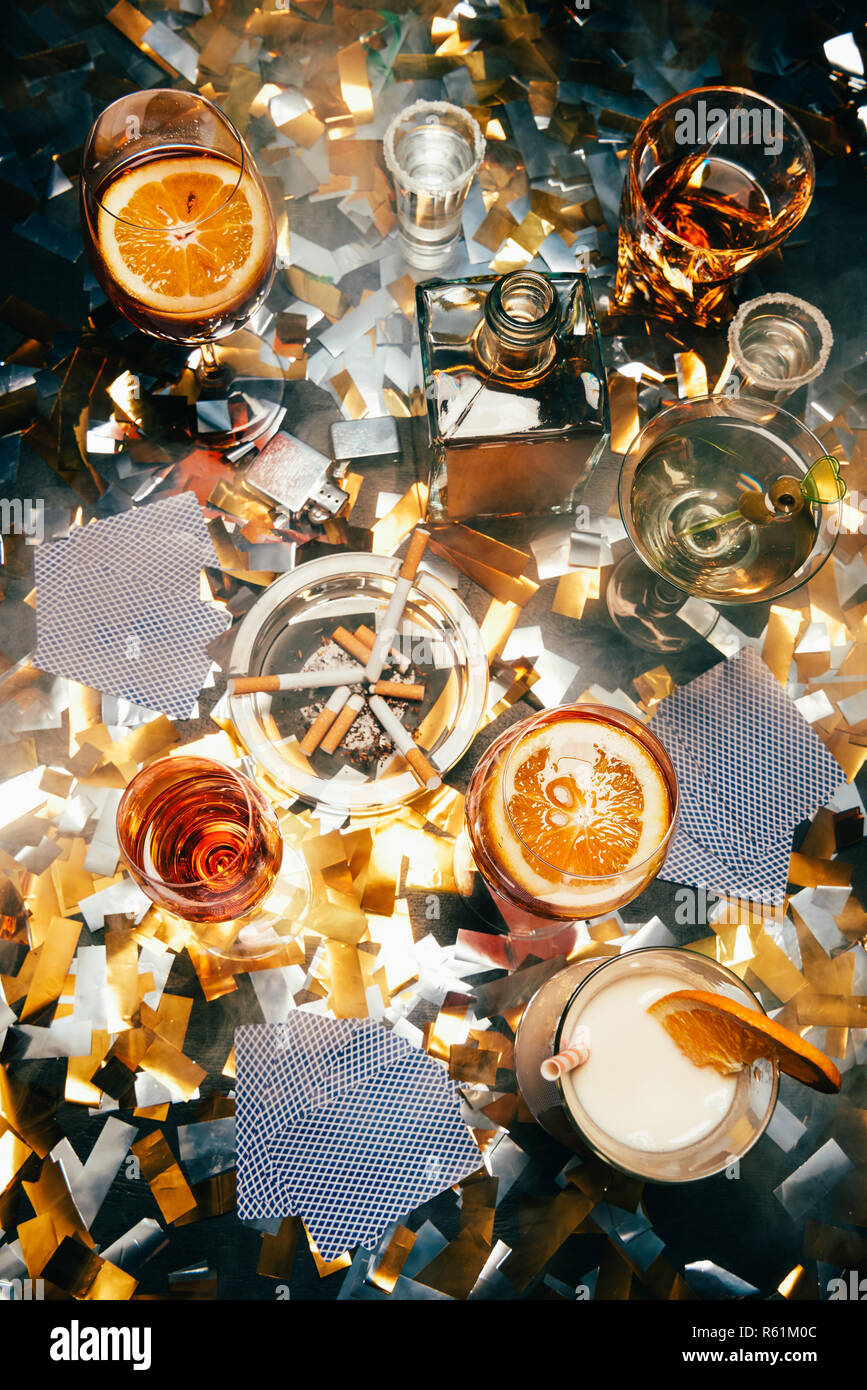 flat lay with cigarettes, alcoholic cocktails, whiskey and playing ...