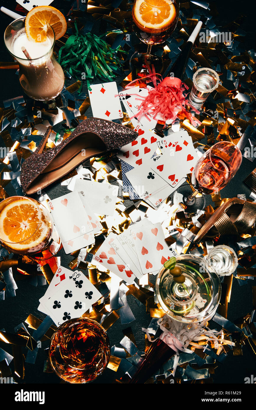 top view of female shoes on high heels, playing cards, alcoholic ...