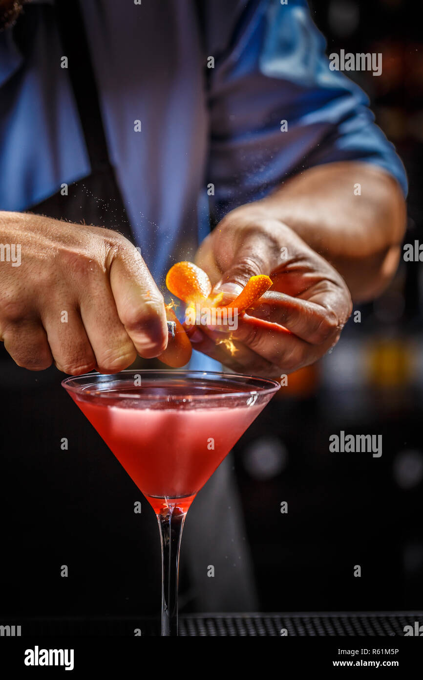 Barman is decorating cosmopolitan cocktail Stock Photo - Alamy