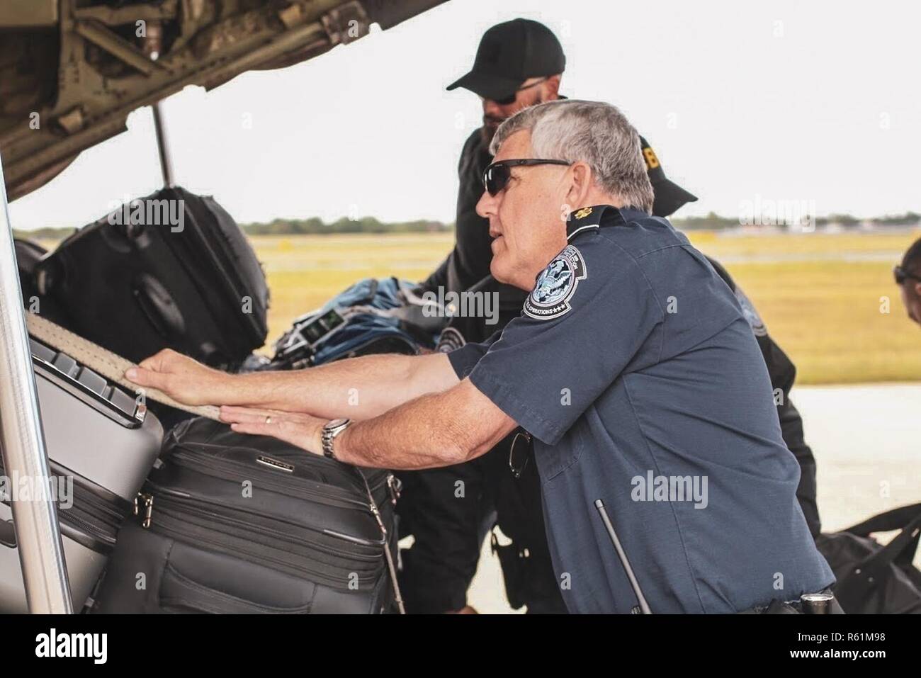 U.S. Customs and Border Protection personnel board a United States Air ...