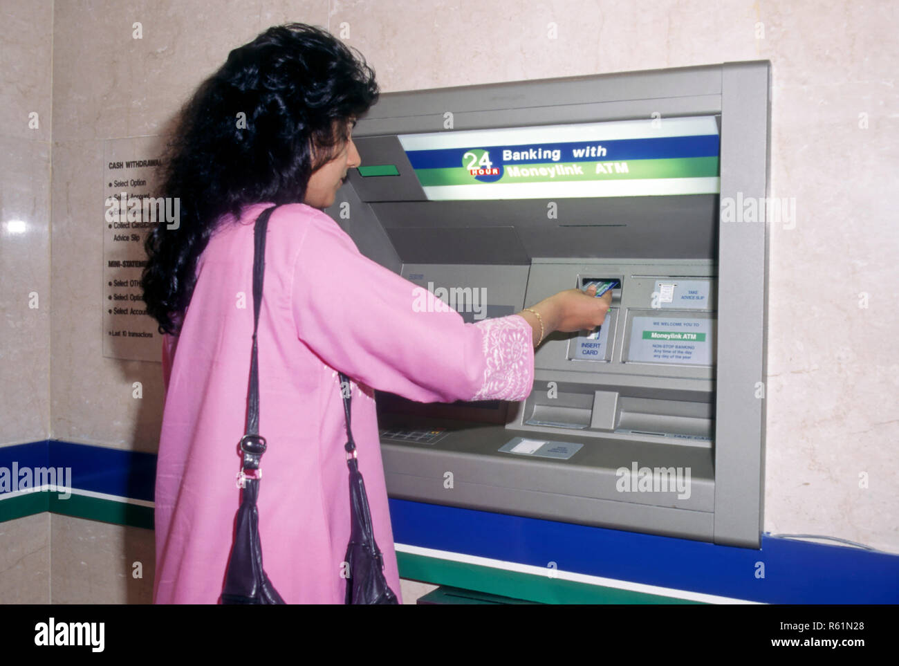 woman operating Any Time Money System ATM, automated bank system Stock ...