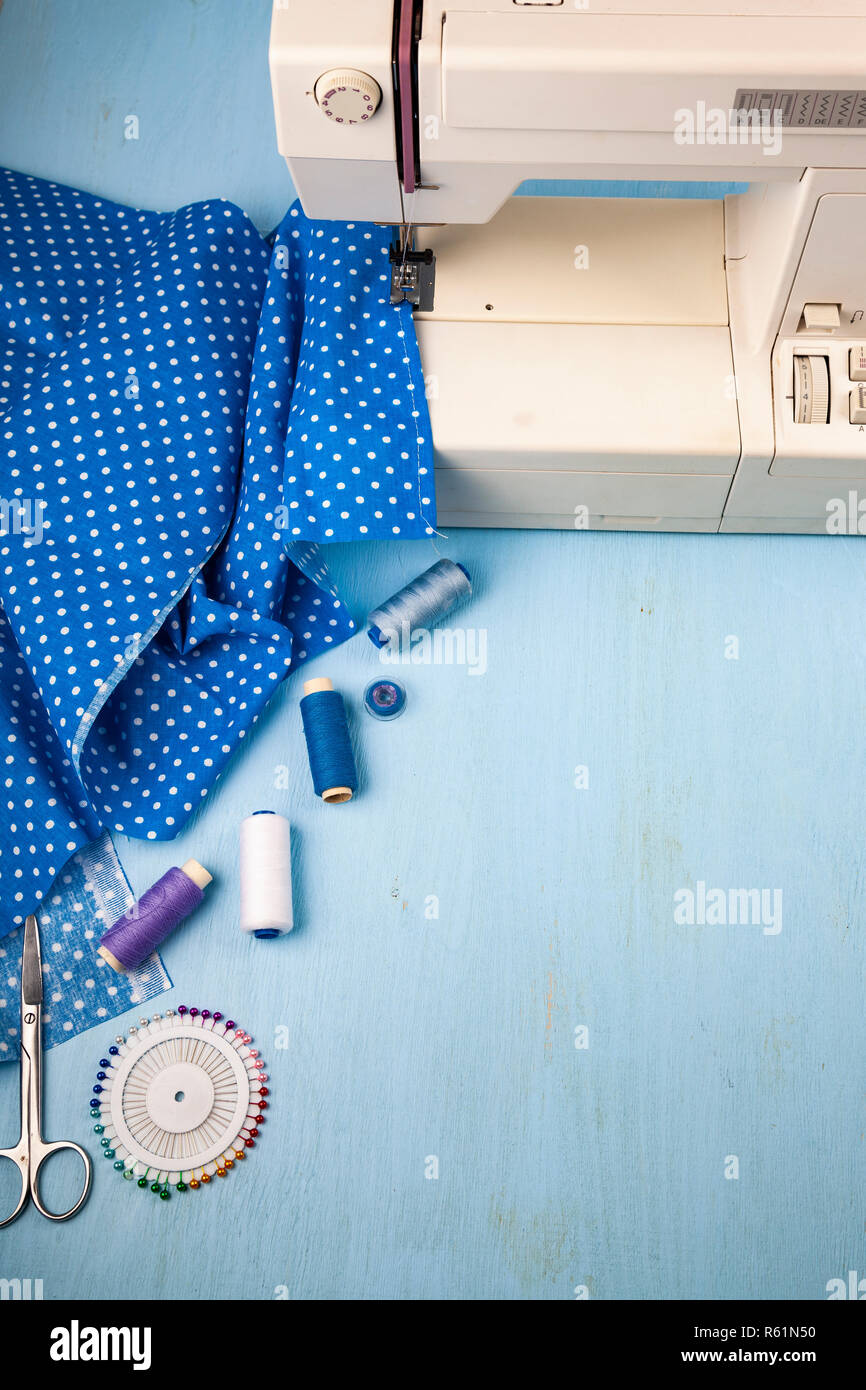 Sewing machine and blue fabric close-up Stock Photo - Alamy