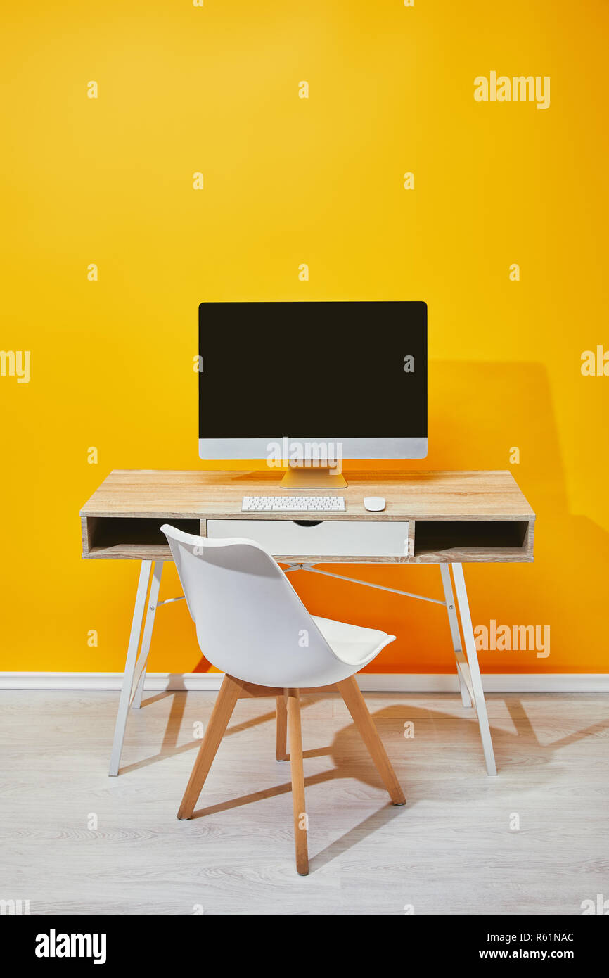 computer at workplace with chair and yellow wall at background Stock ...