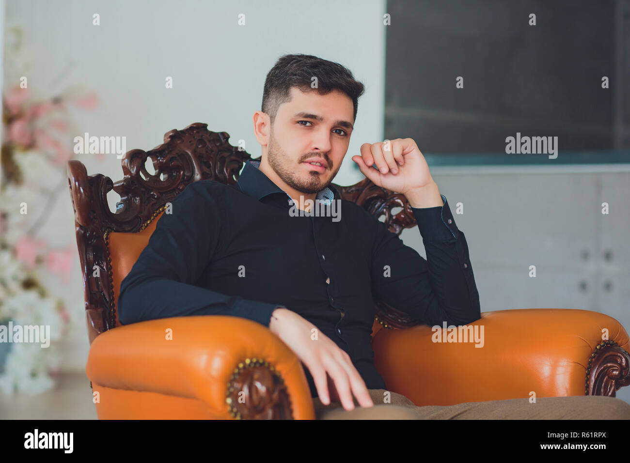 Handsome young man home sitting on couch Stock Photo - Alamy