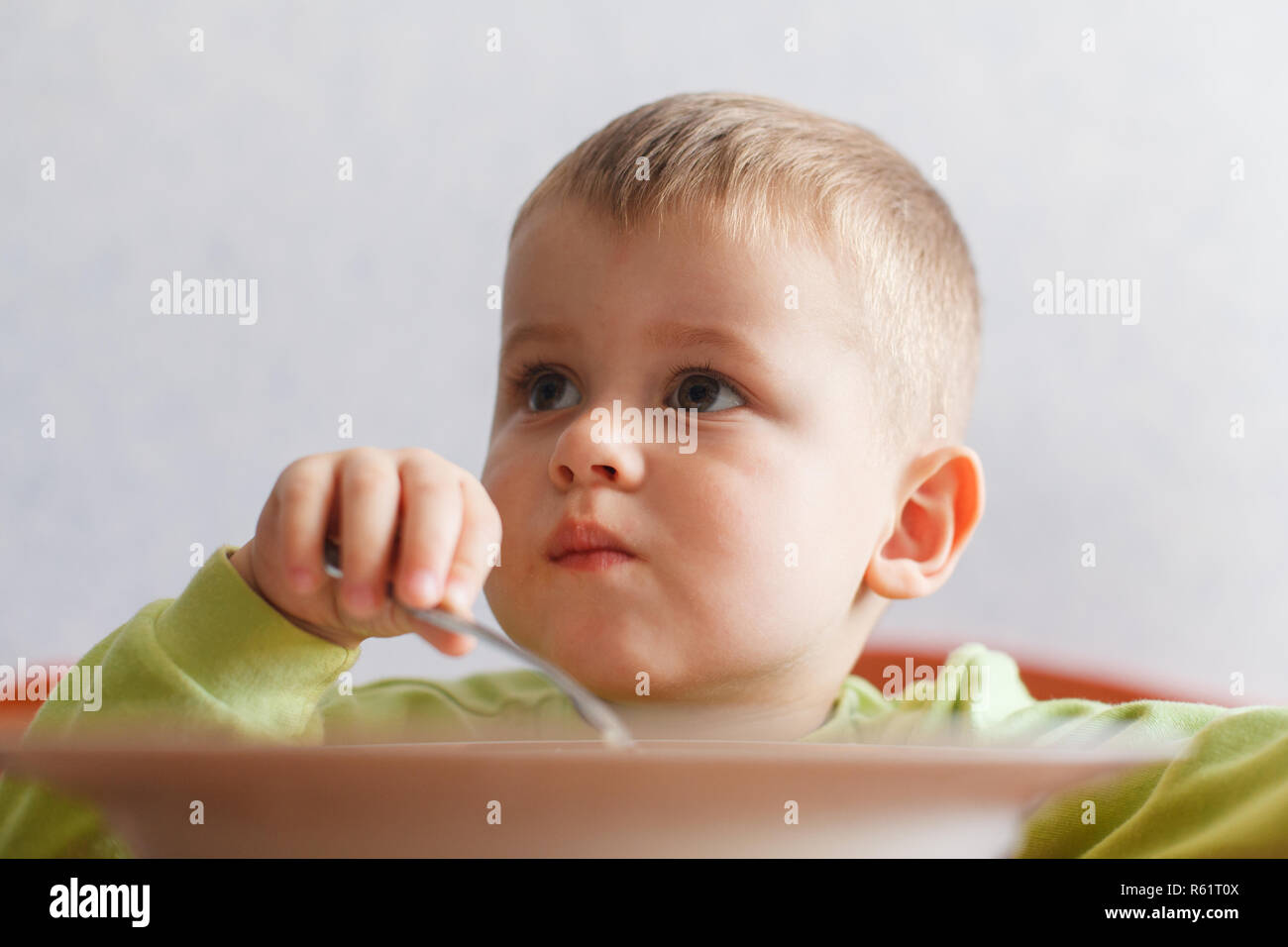 Hungry child eats lunch with big appetite. Cute boy eats pasta. Food ...