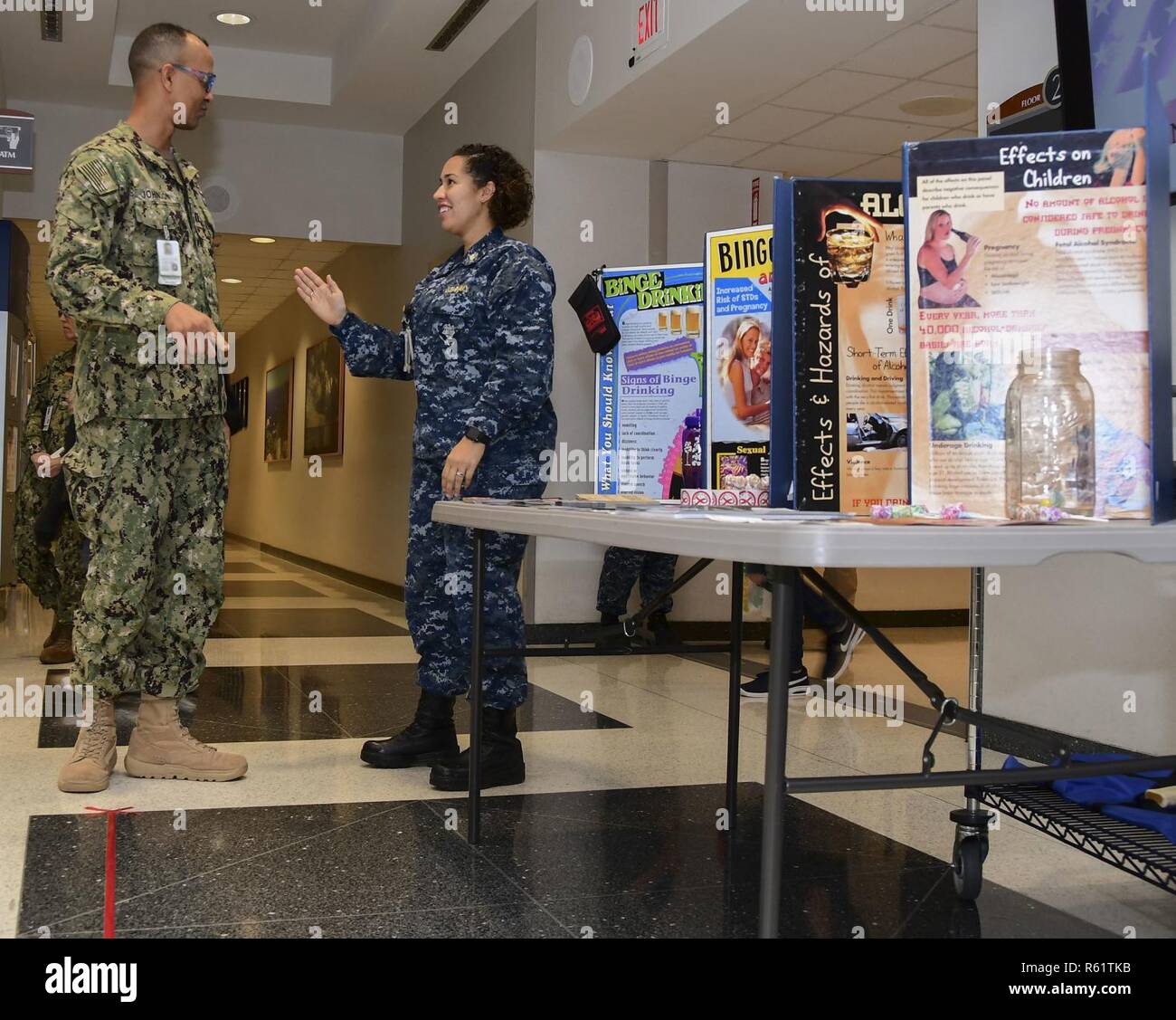 Lt. j.g. Nicole Morris, command DAPA, explains to Lt. Jermaine Johnson ...