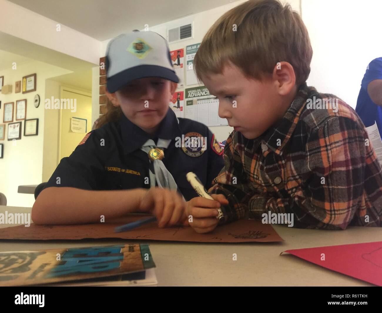 Addison Conley, 8, and Avery Gurule, 4, draw a poster at the start of ...