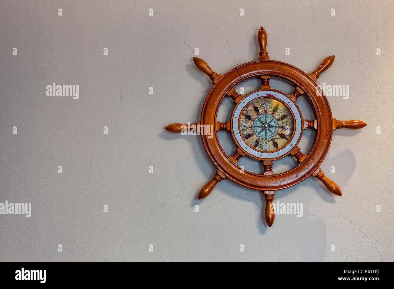 Concept: travel, sea navigation. Ship's nautical steering wheel and old ...
