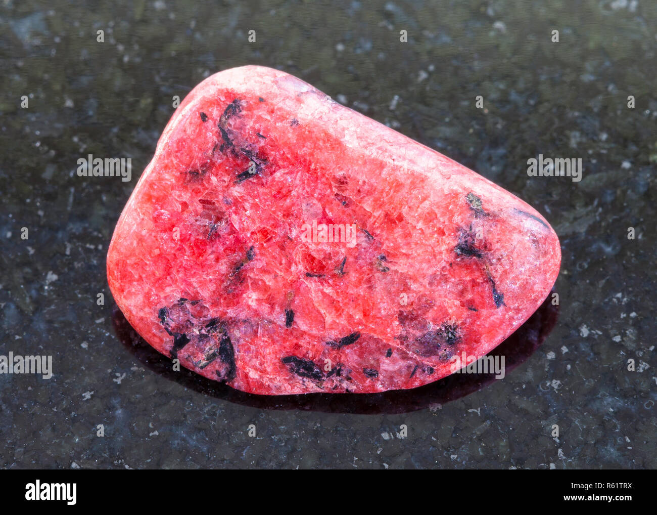 tumbled red Agate gemstone on dark background Stock Photo - Alamy