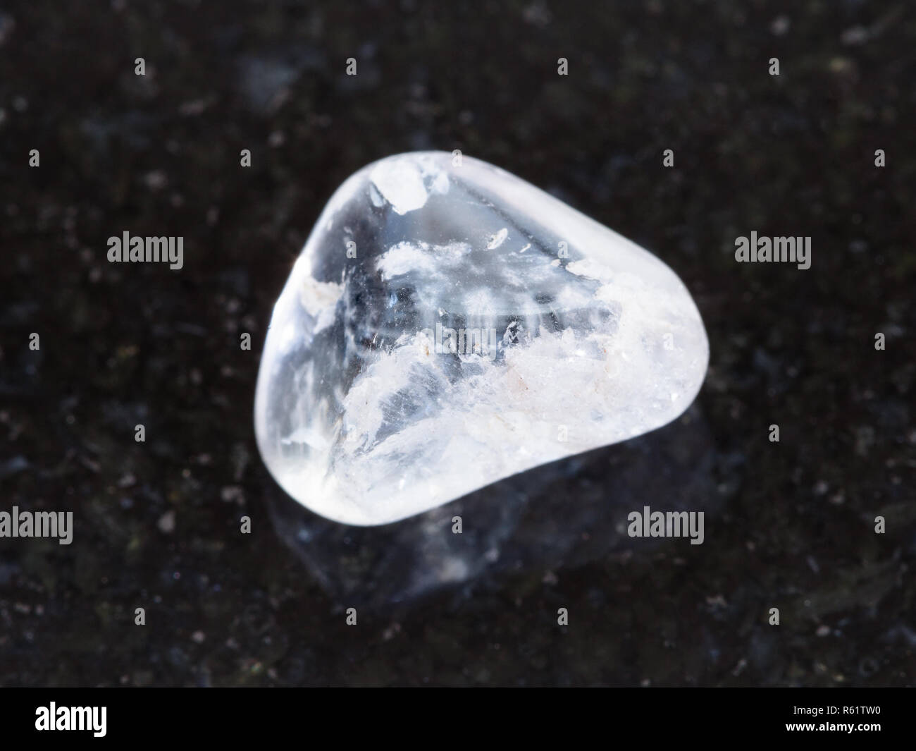 tumbled rock crystal gemstone on dark background Stock Photo - Alamy
