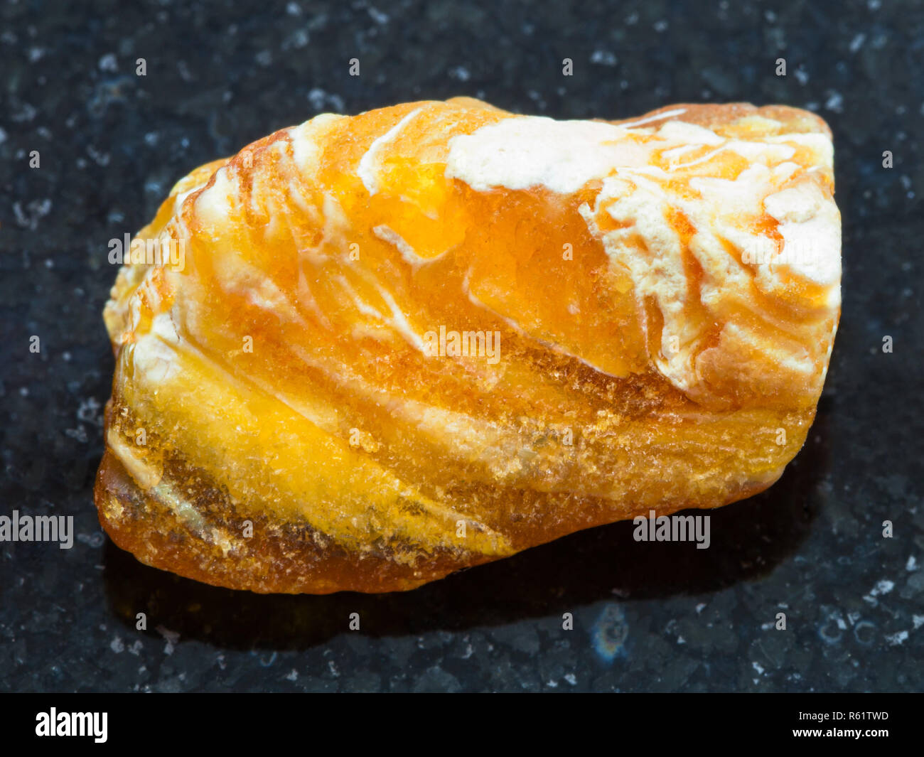 pebble of baltic Amber stone on dark Stock Photo - Alamy