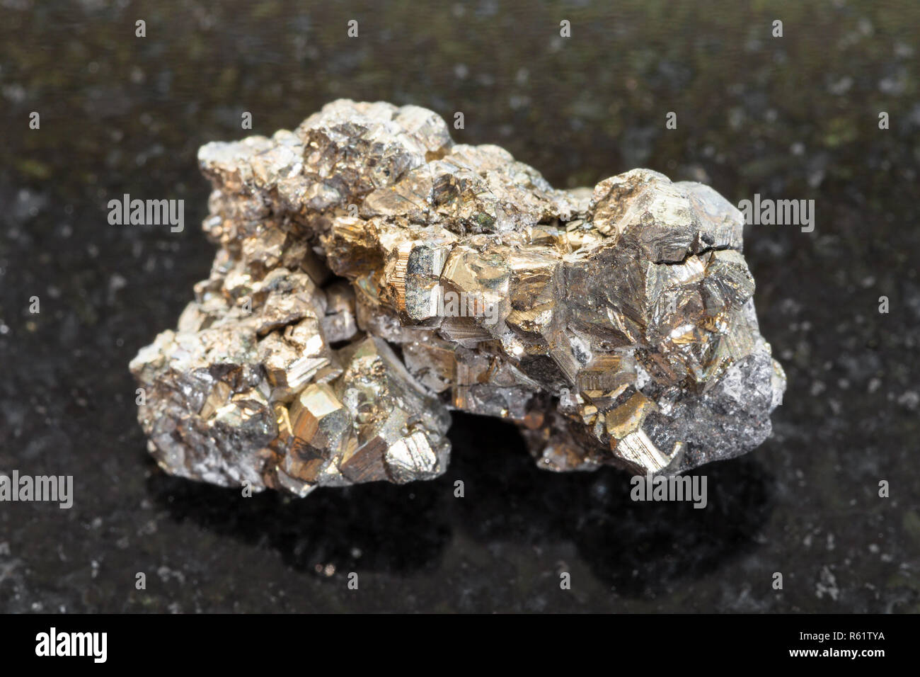 rough pyrite stone on dark background Stock Photo - Alamy
