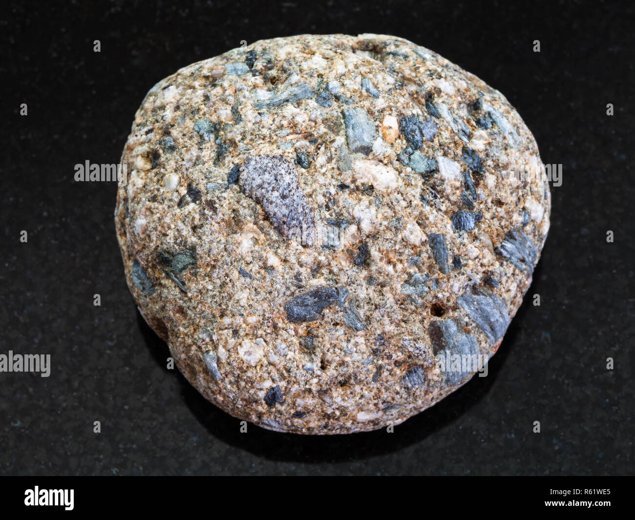 pebble of Arkose sandstone on dark background Stock Photo - Alamy