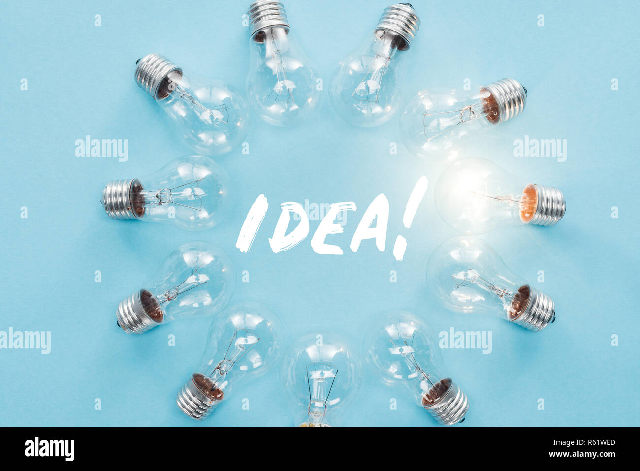 circle of light bulbs with glowing one surronding 'idea' word, having ...