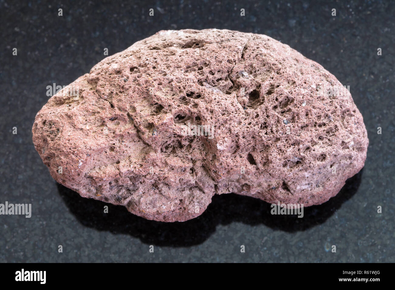 red pumice stone on dark background Stock Photo - Alamy