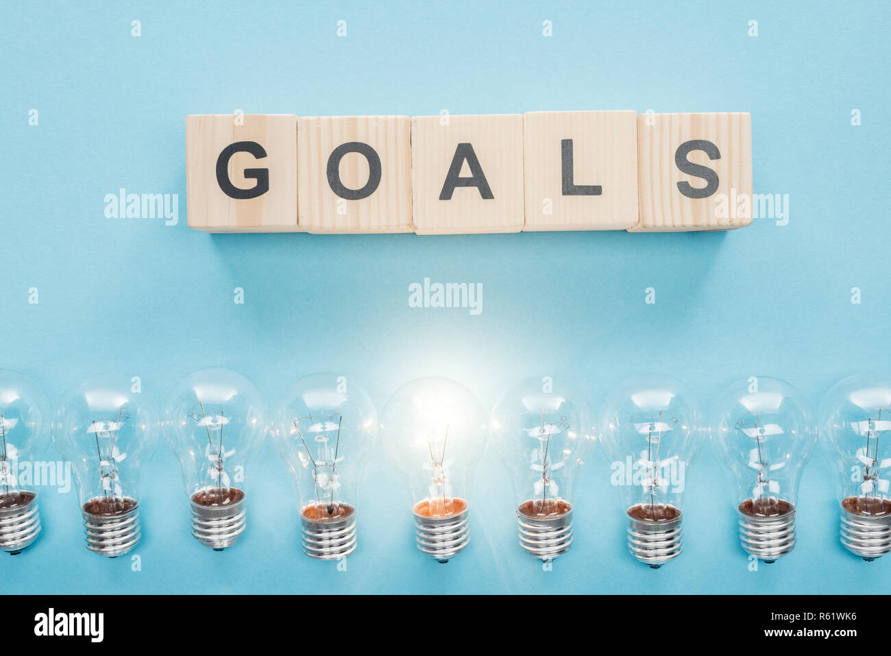 top view of glowing light bulbs under 'goals' word made of wooden ...