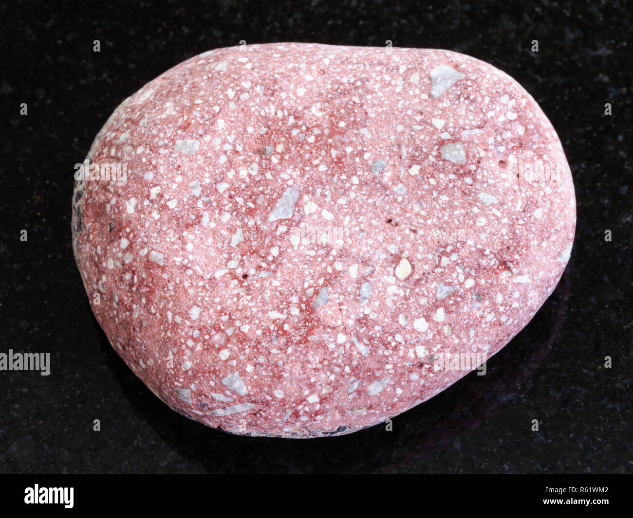 pebble of pink Arkose sandstone on dark background Stock Photo - Alamy
