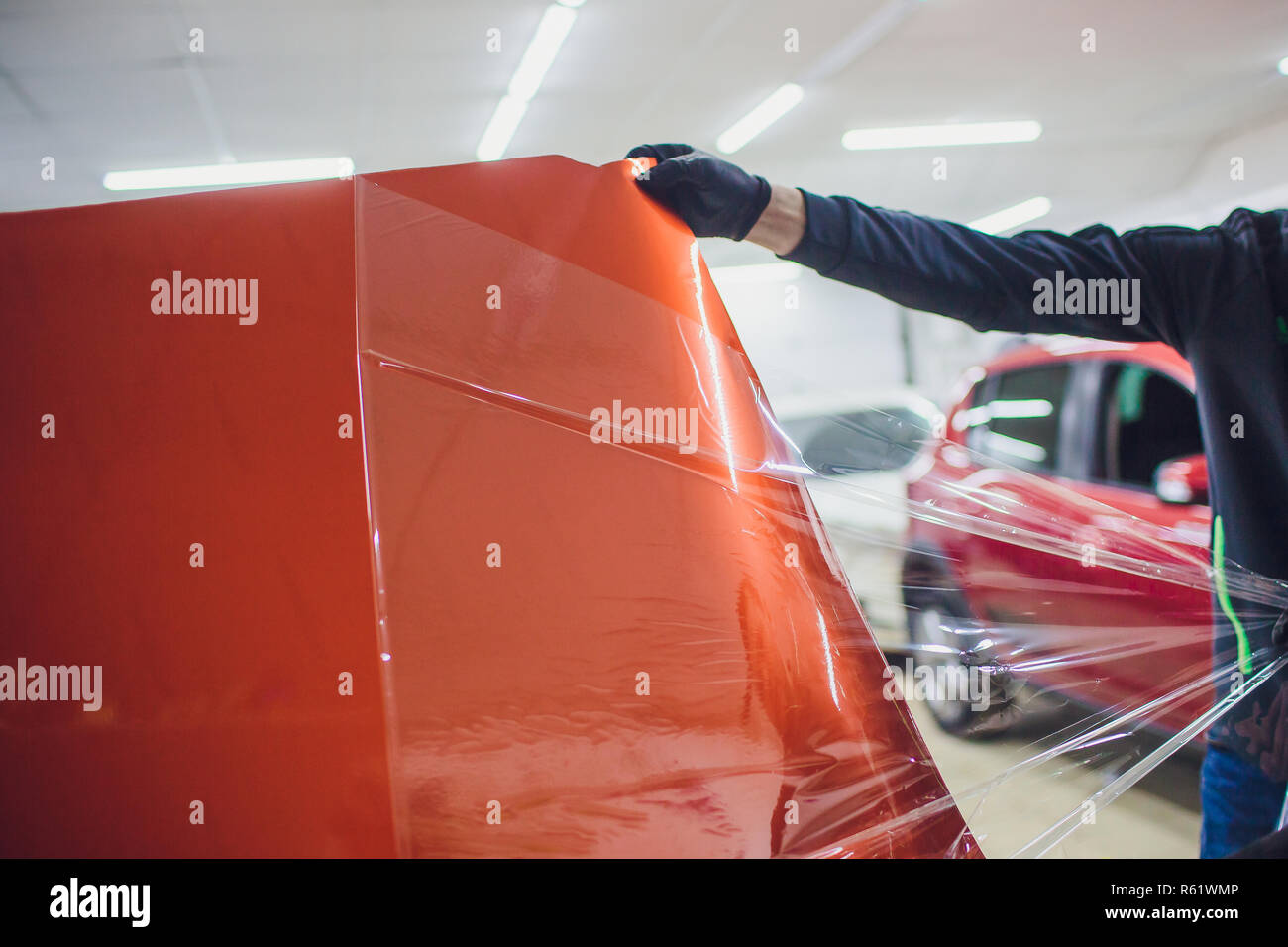Car wrapping specialist putting vinyl foil or film on car wrapping ...