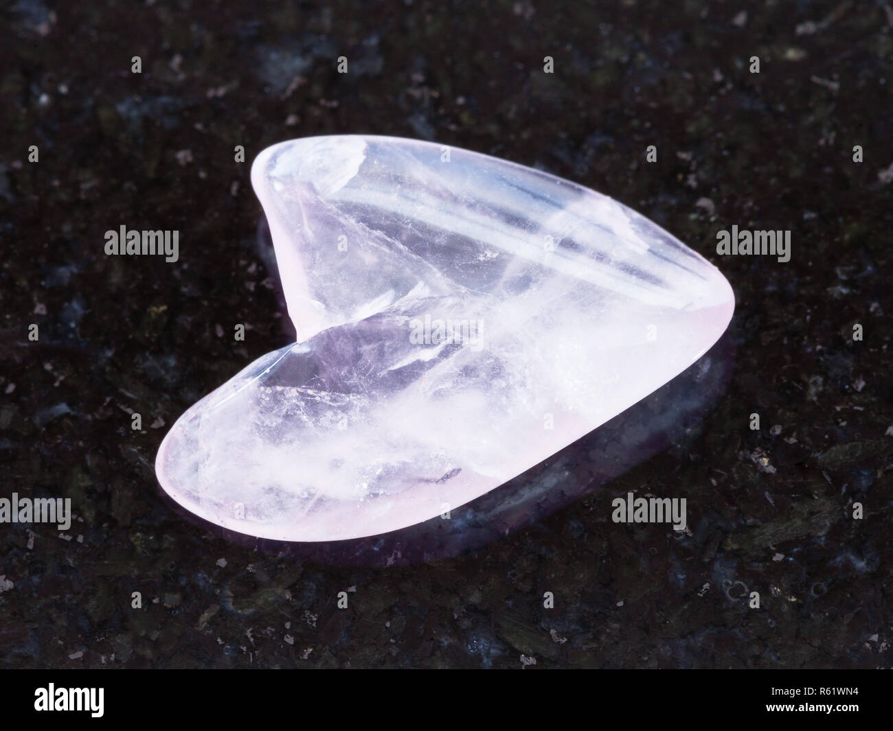 polished rose quartz stone in heart shape on dark Stock Photo - Alamy
