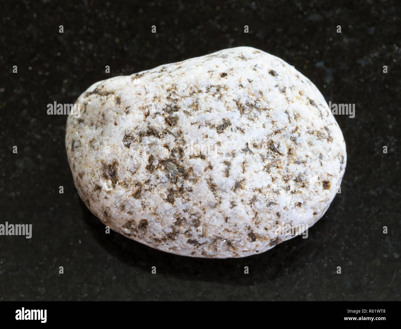 tumbled of white Granite stone on dark background Stock Photo - Alamy
