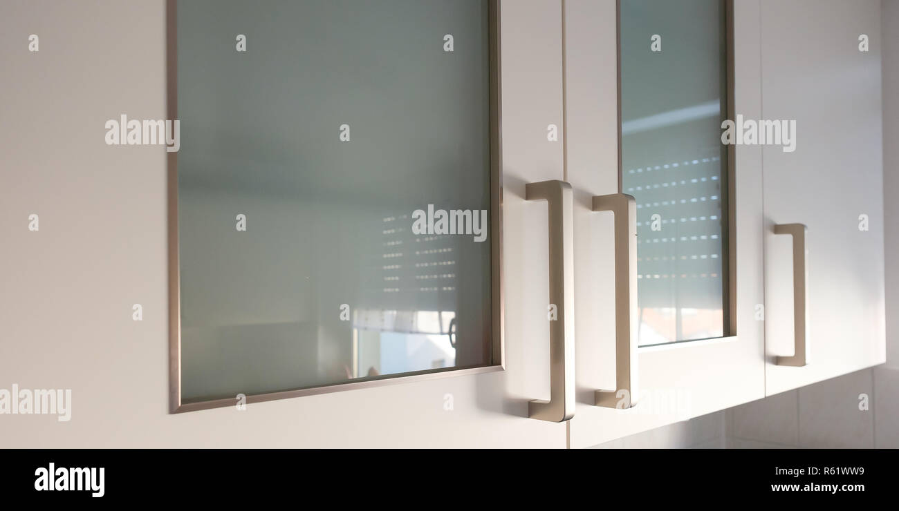 wall unit with metal handle in kitchen Stock Photo - Alamy