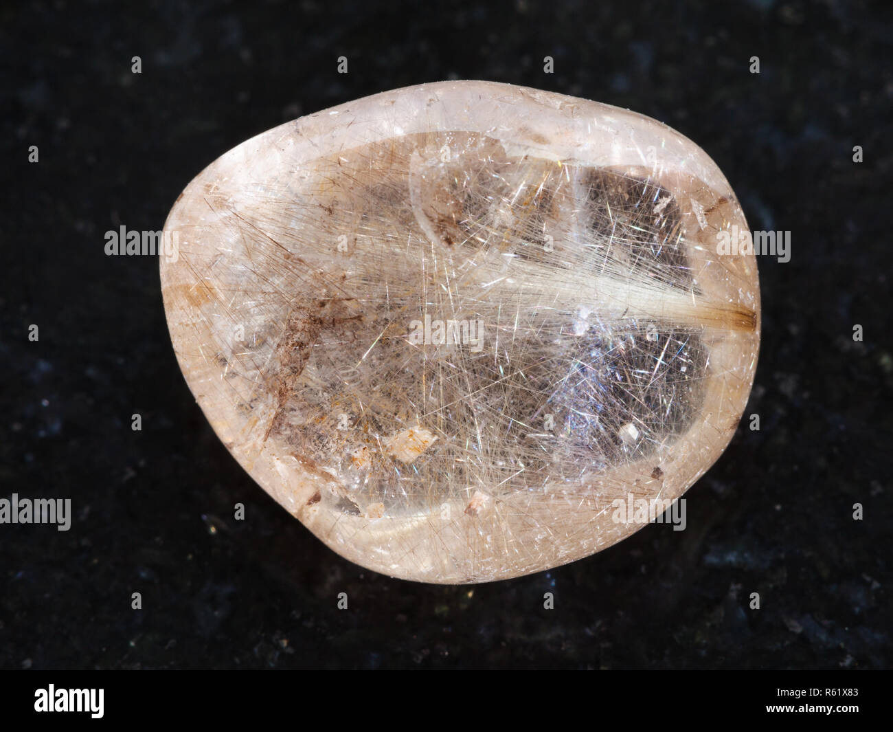 polished Rutilated Quartz gemstone on dark Stock Photo - Alamy