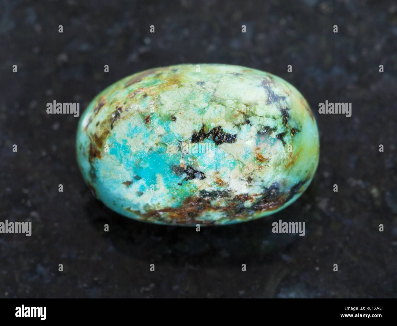 polished turquoise gemstone on dark background Stock Photo - Alamy