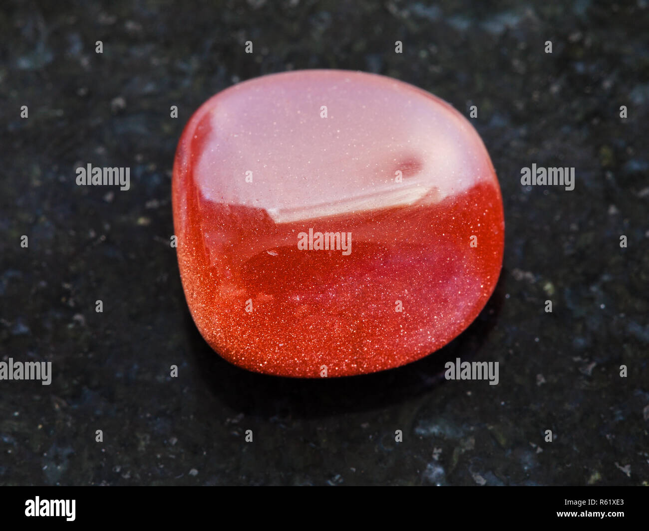 polished red goldstone gemstone on dark Stock Photo - Alamy