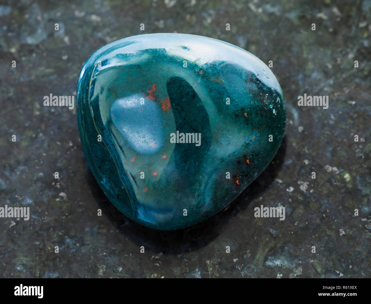 Macro shooting of natural mineral stone tumbled heliotrope bloodstone ...
