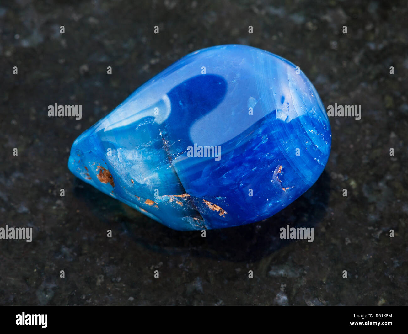 tumbled blue toned agate gemstone on dark Stock Photo - Alamy