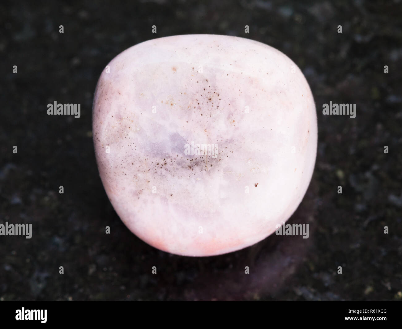 polished rhodonite gem stone on dark Stock Photo - Alamy