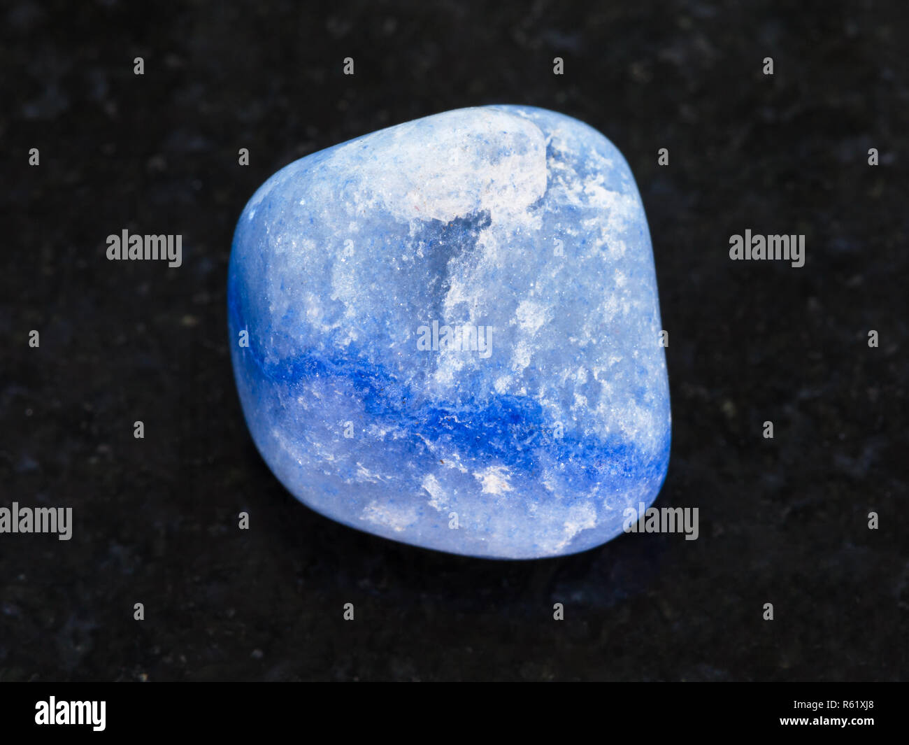 tumbled blue dyed agate gemstone on dark Stock Photo - Alamy