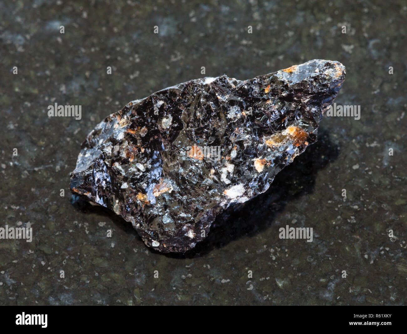 raw obsidian (volcanic glass) stone on dark Stock Photo - Alamy
