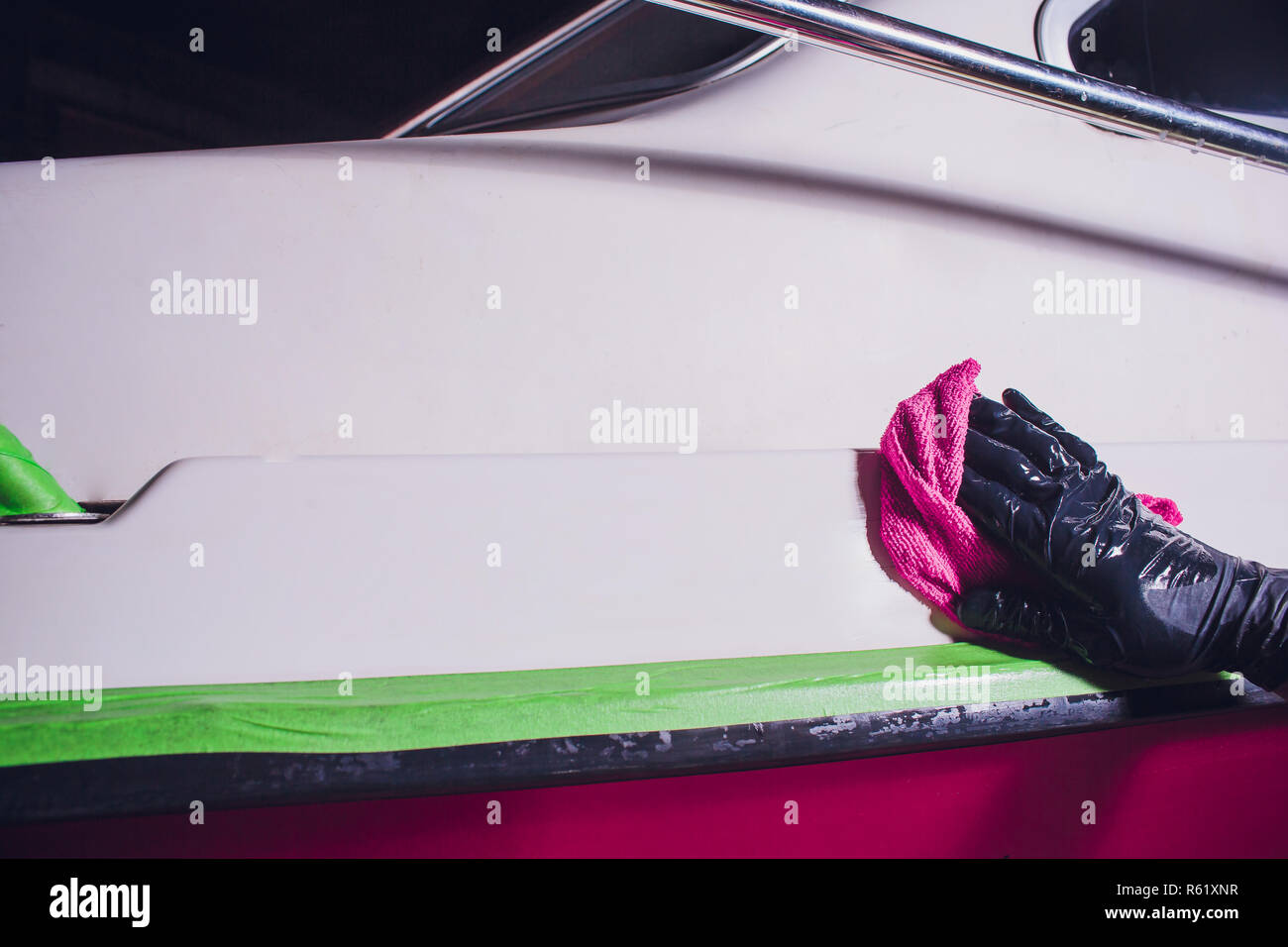 Man washes deck yacht with pink rag. preparation in polishing, repair ...