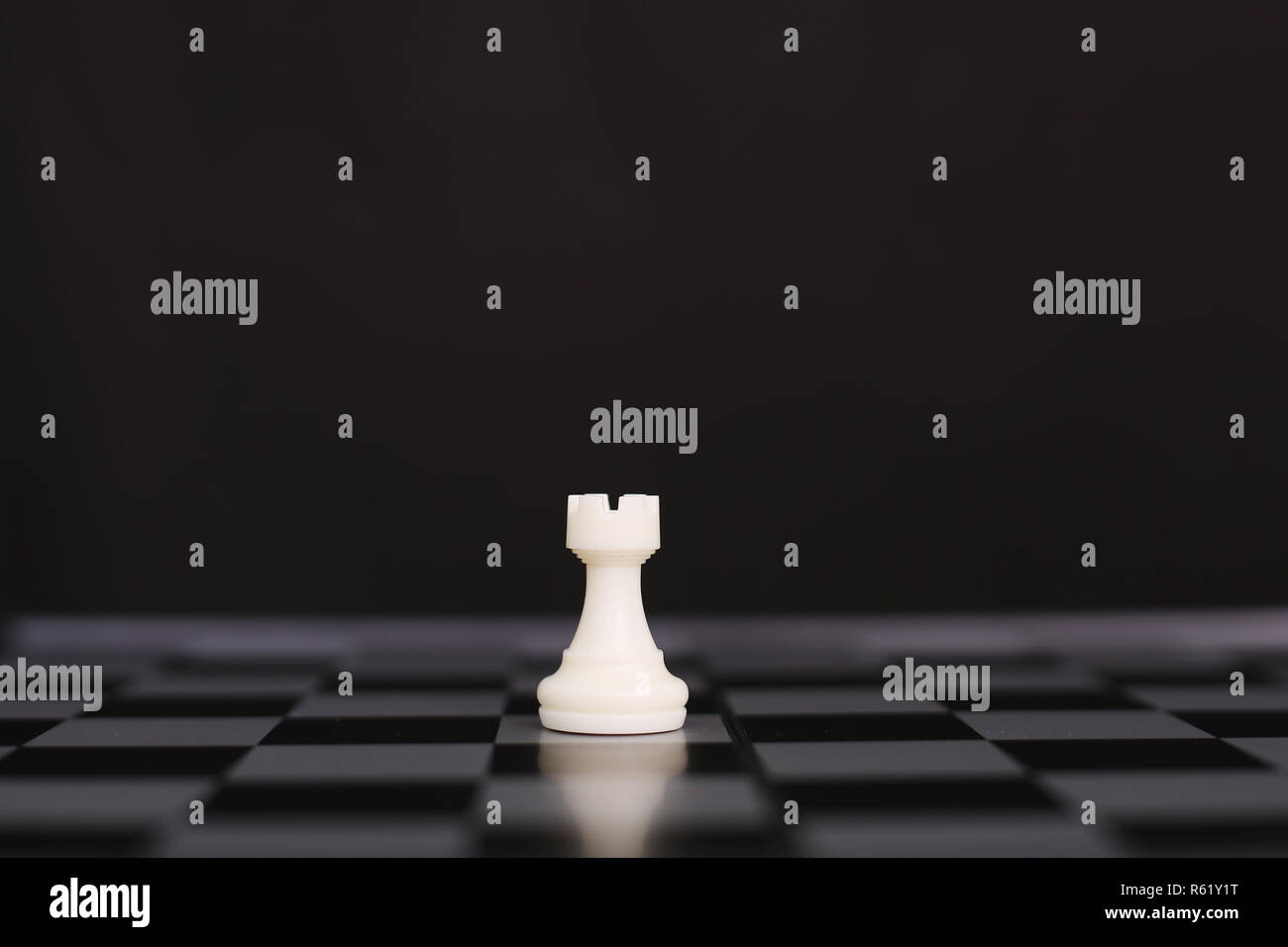 White chess pawn on the chess board. Isolated on the black background ...