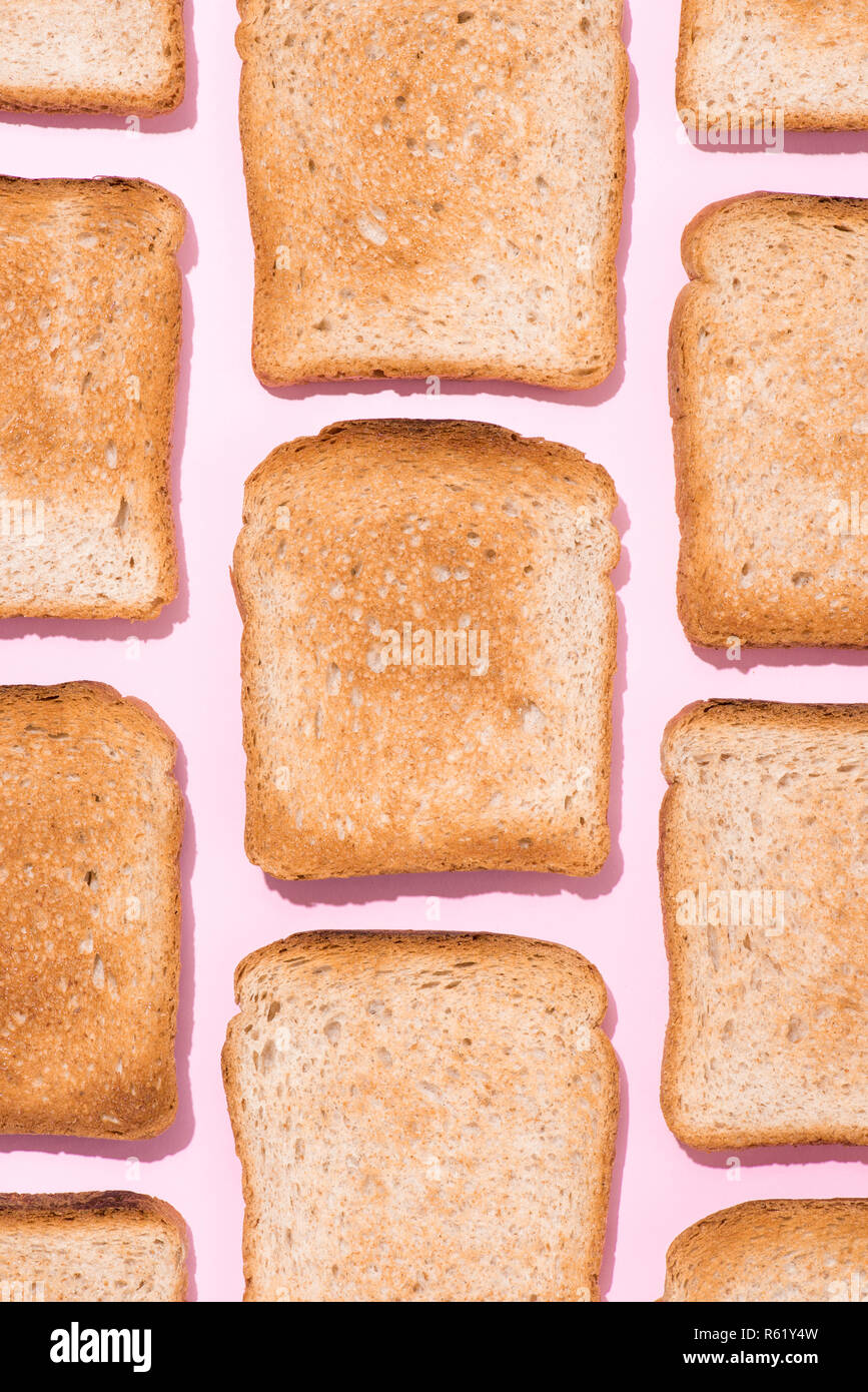 top view of pattern of crispy toasts on pink surface Stock Photo - Alamy
