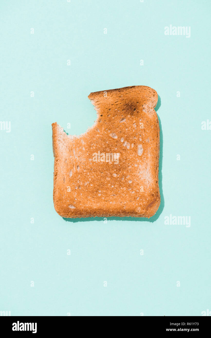 top view of bitten crunchy toast on blue surface Stock Photo - Alamy