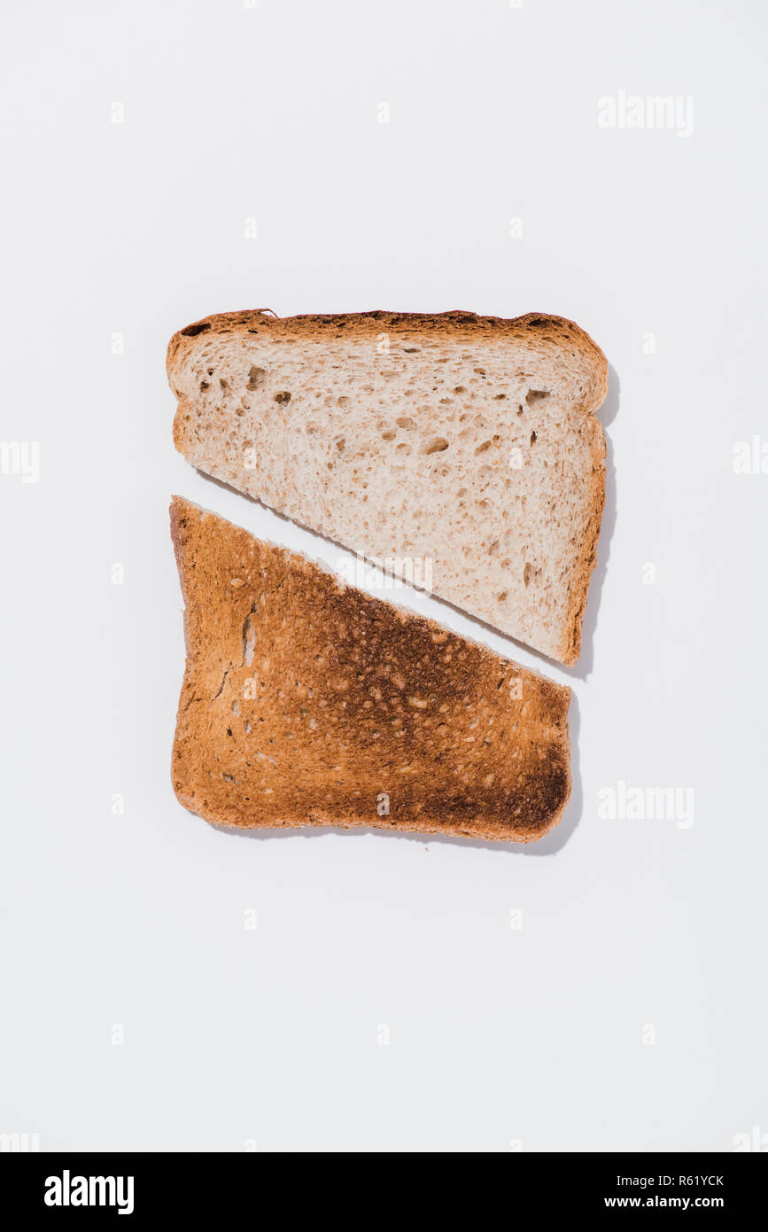 top view of slice of bread with roasted half on white surface Stock ...