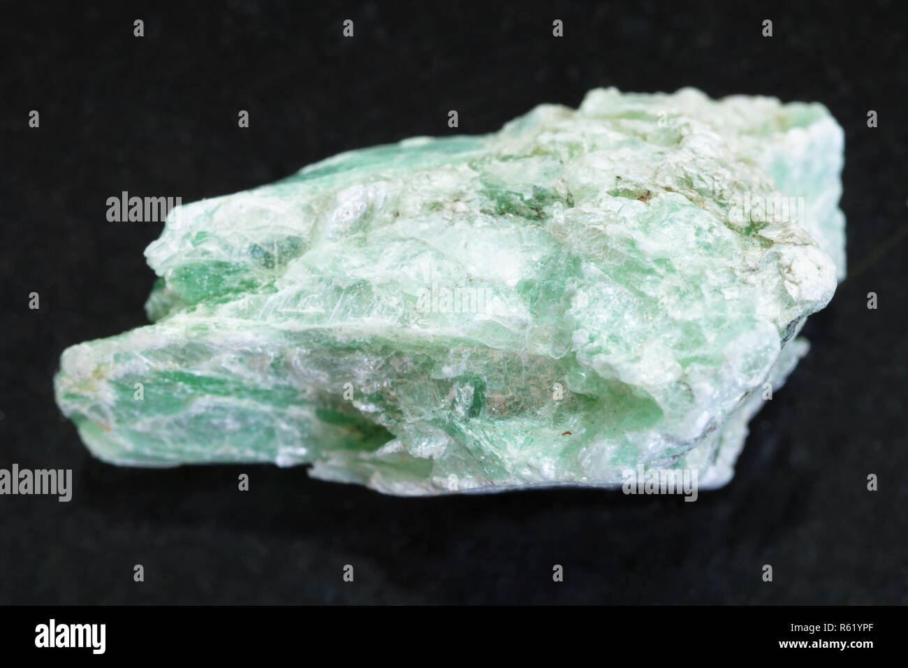 raw green talc stone on dark background Stock Photo - Alamy