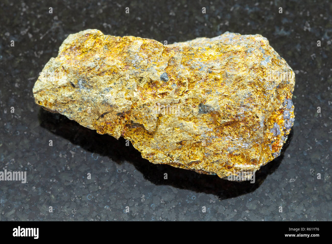 raw pyrite ore on dark background Stock Photo - Alamy