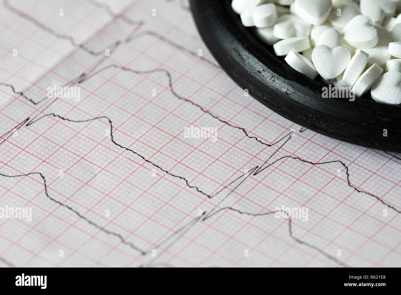 Cardiology. Macro of ECG graph and cardio pills. Pills as a heart Stock ...