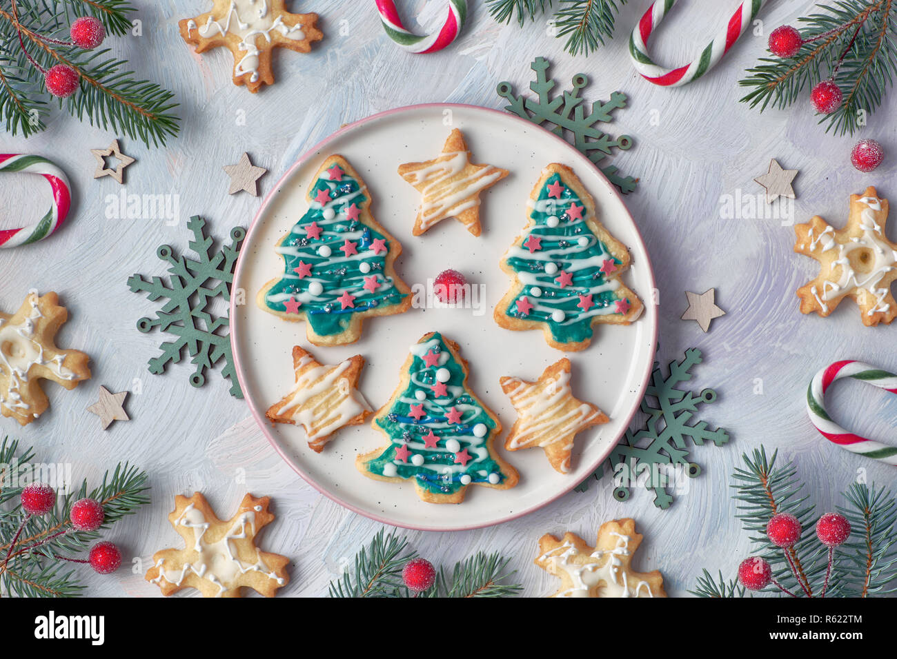 Christmas cookies with fir twigs, candy canes, snowflakes and berries ...