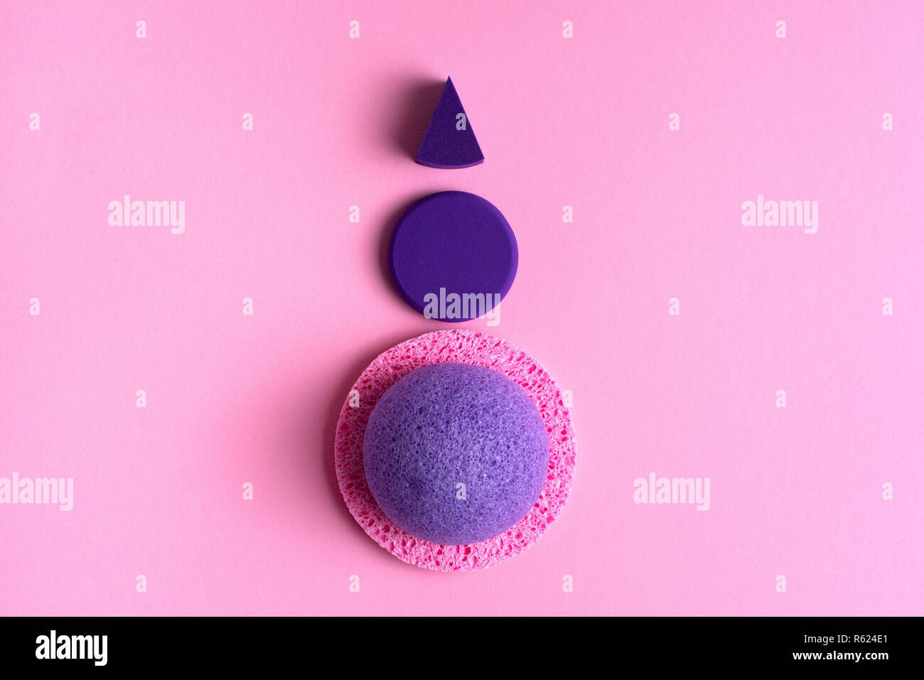 Cosmetic sponge for the face on a pink background. A top view of Flat ...