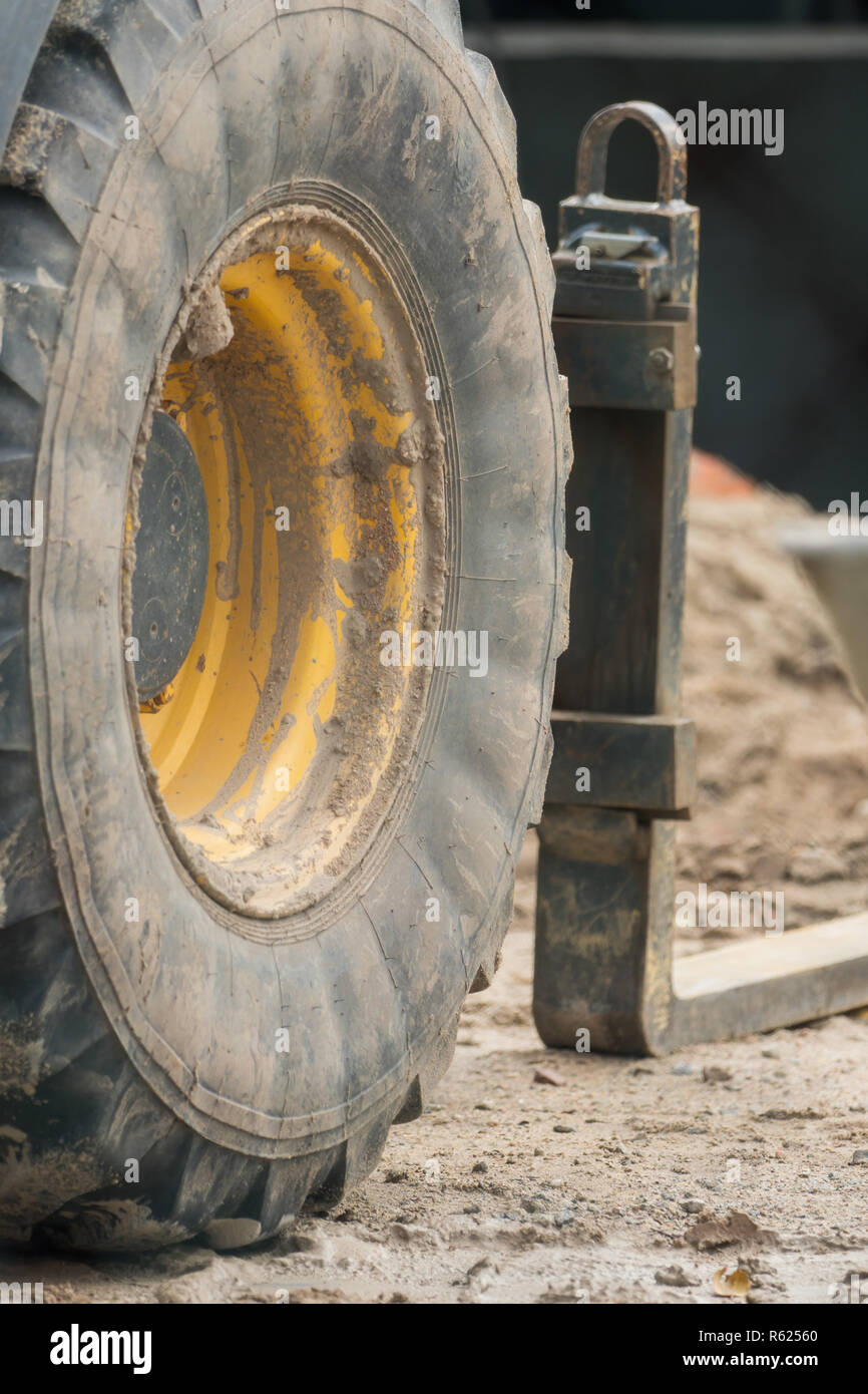 Front wheel of an excavator on the construction site Stock Photo - Alamy