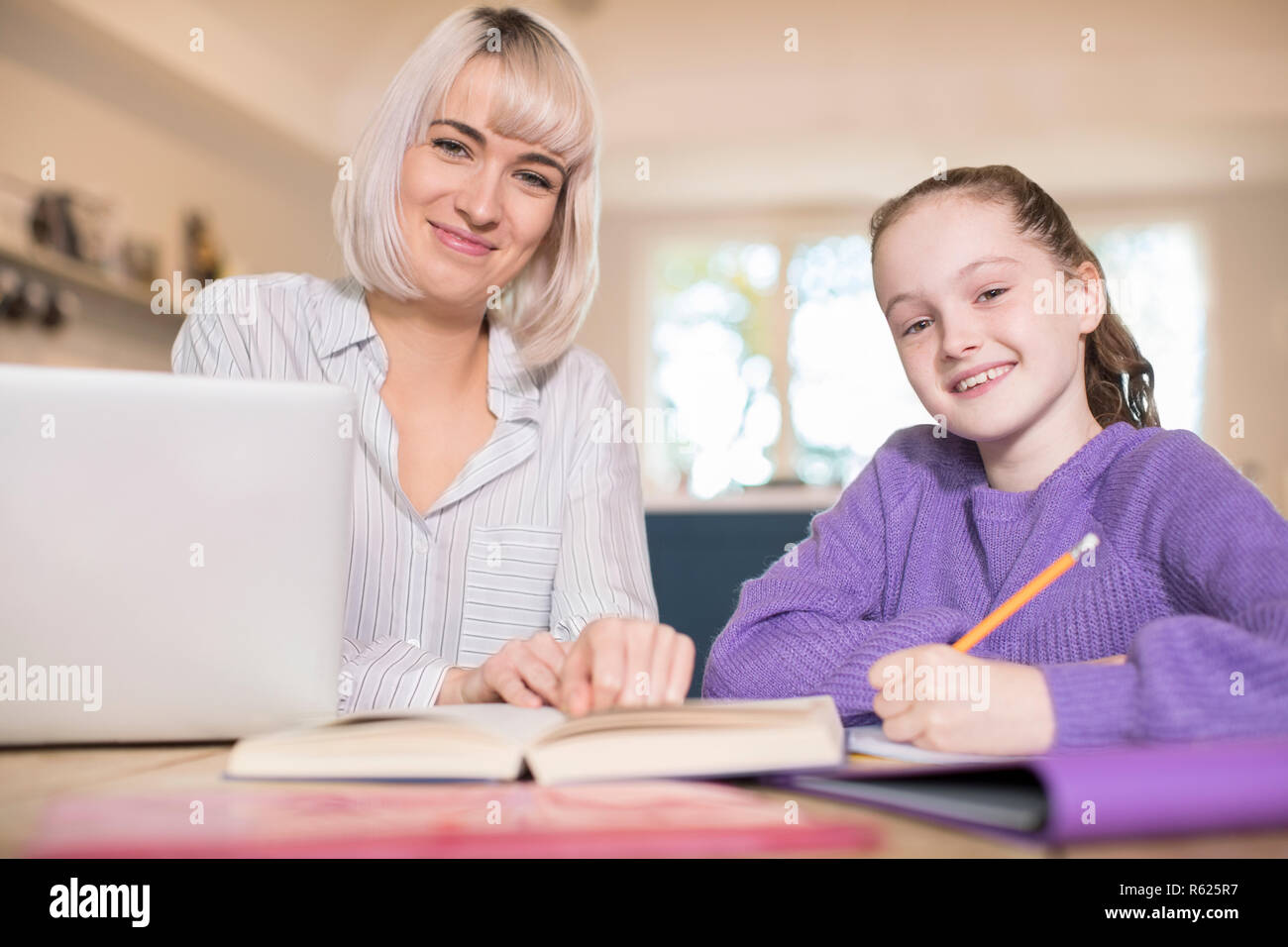 Portrait Of Female Home Tutor Helping Young Girl With Studies Stock ...